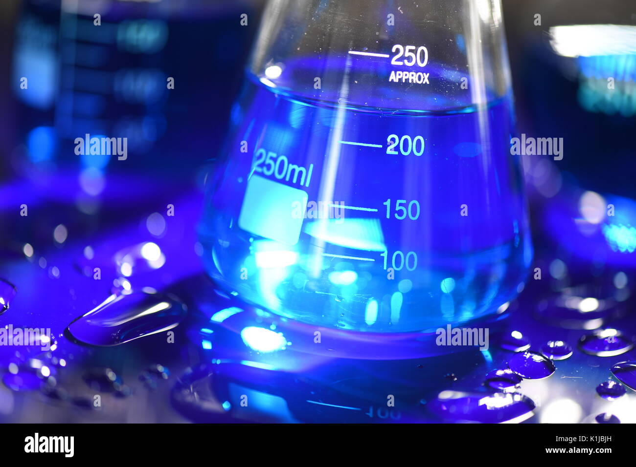 Graduated Conical Science Beakers on blue acrylic Stock Photo - Alamy