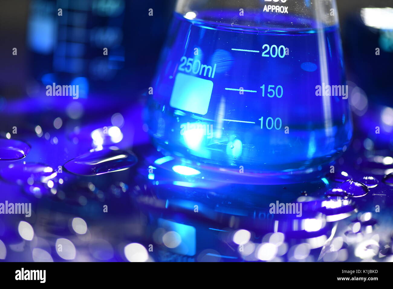 Graduated Conical Science Beakers on blue acrylic Stock Photo - Alamy