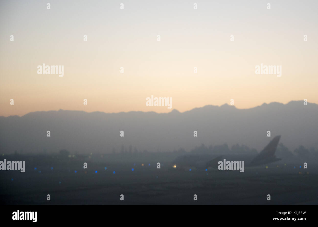 Airplane in the mist at sunrise Stock Photo - Alamy