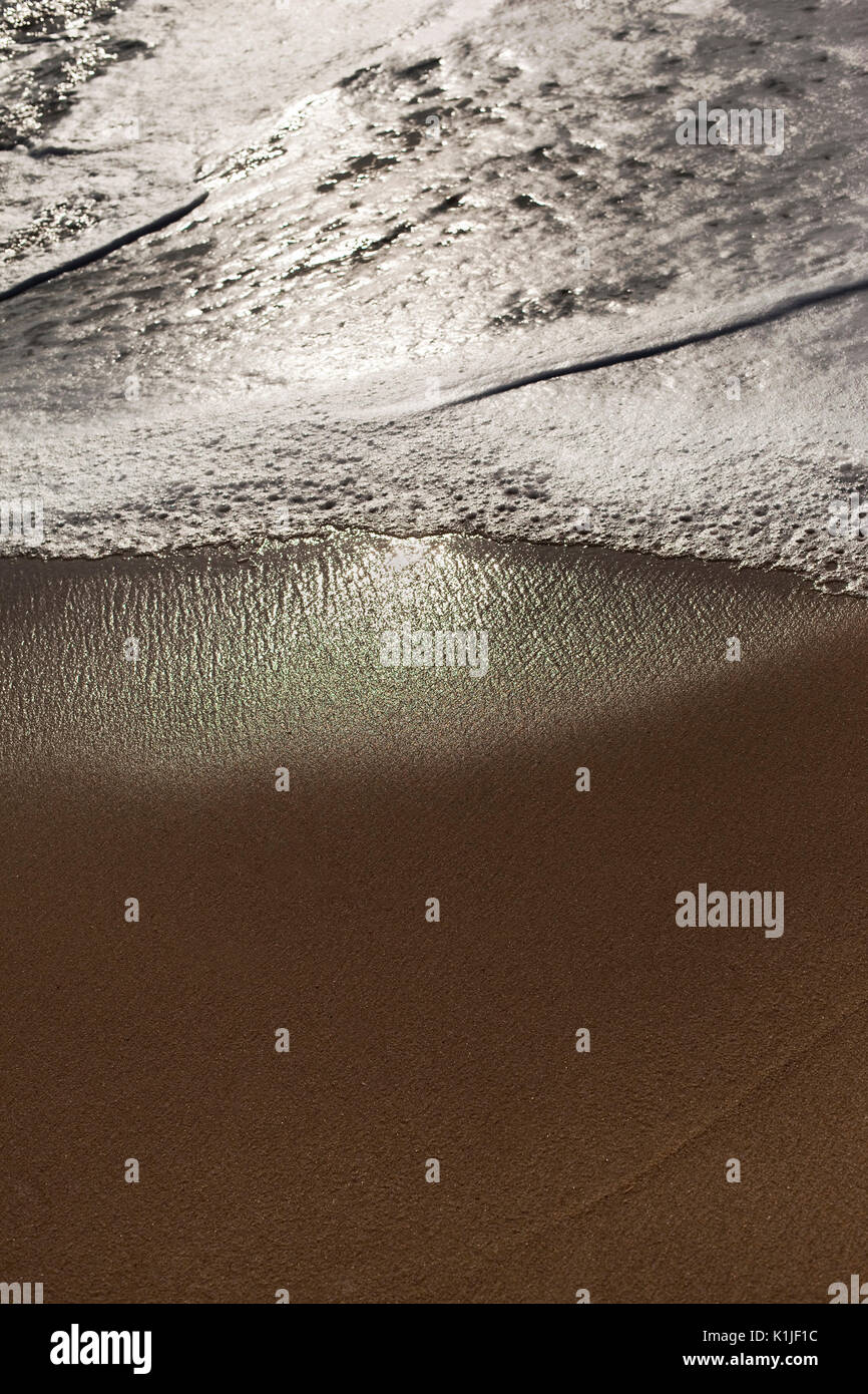 Surf of the sea on the sand of the beach Stock Photo - Alamy