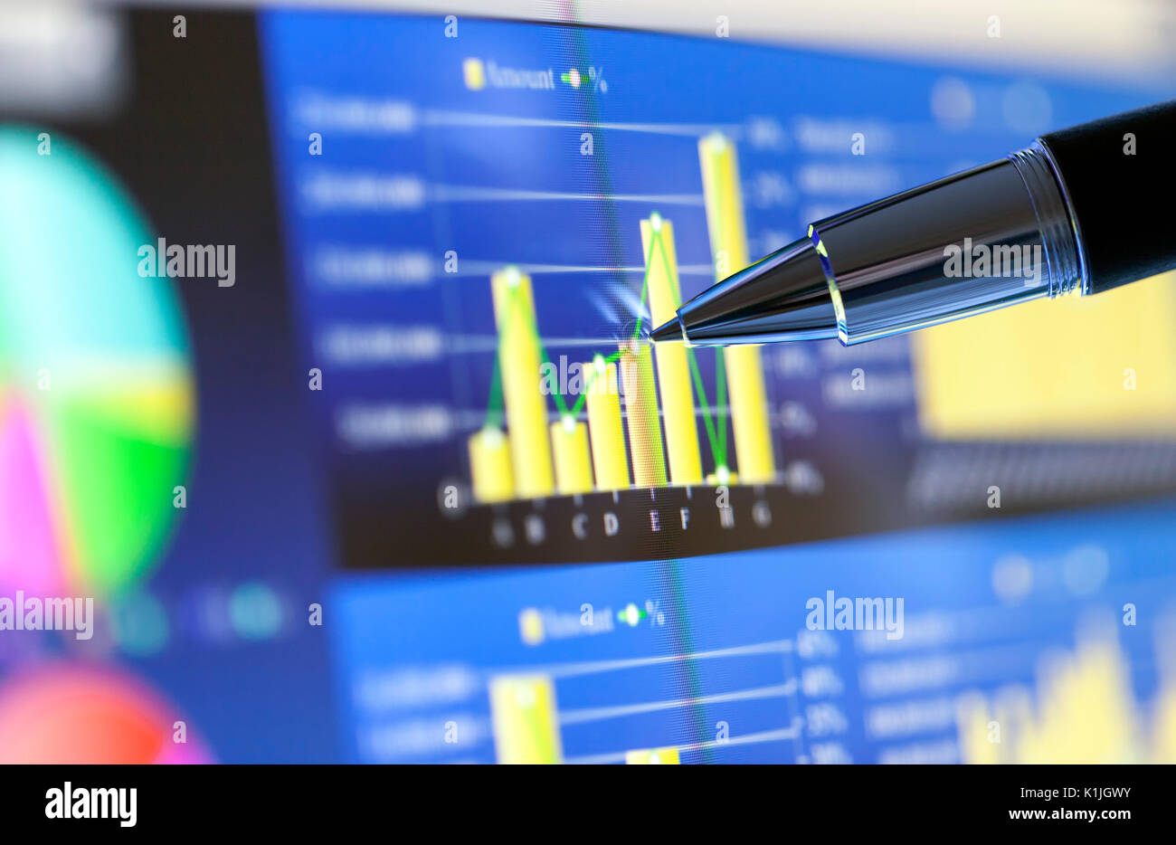 Analyzing stock market from a digital computer screen over a detailed ...