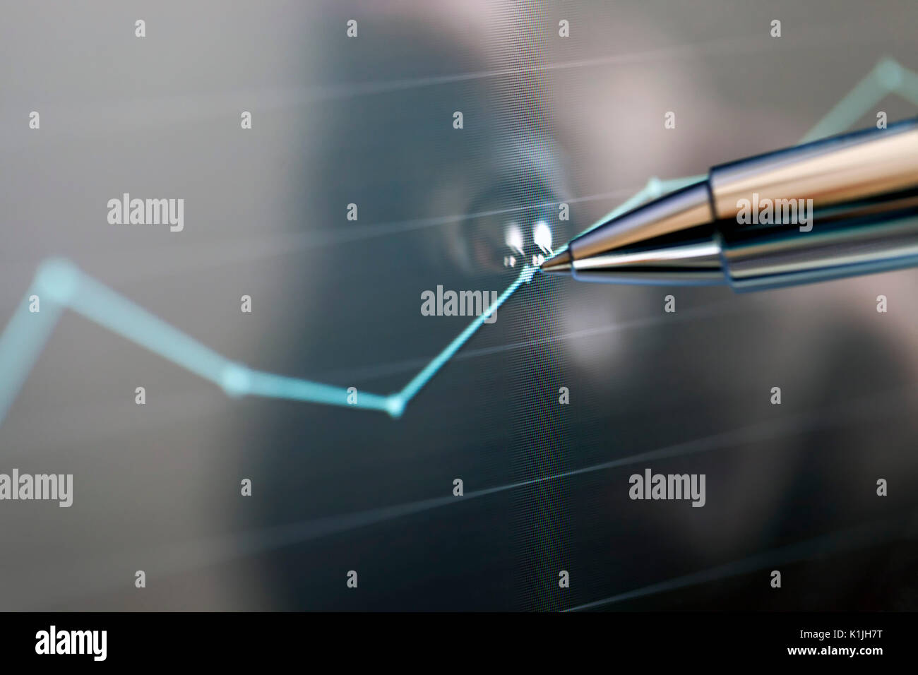 Analyzing stock market from a digital computer screen over a detailed ...