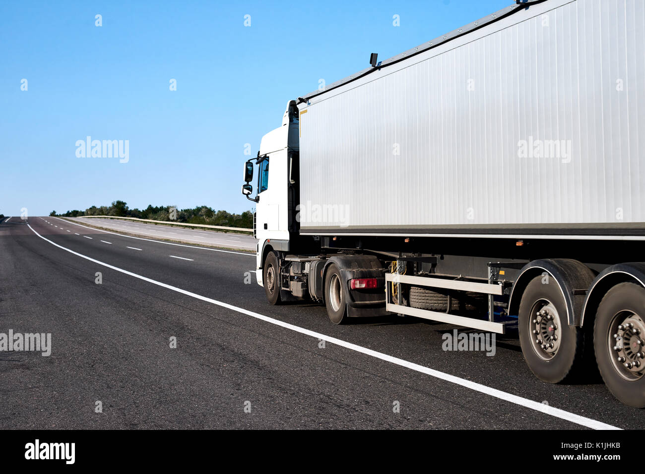 Truck on road with blank container, cargo transportation concept Stock ...