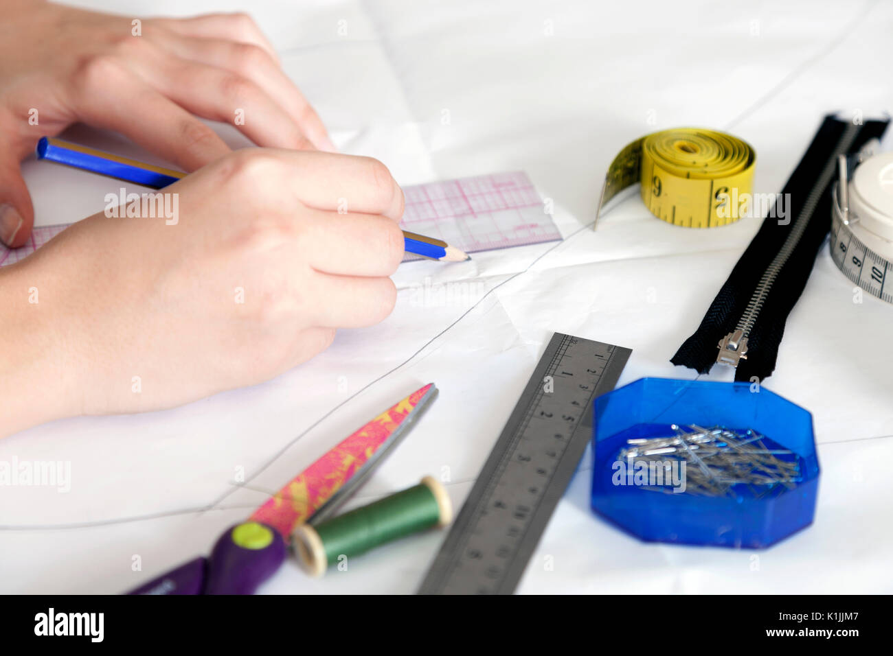 Female fashion designer or student is designing and sketching her new ...