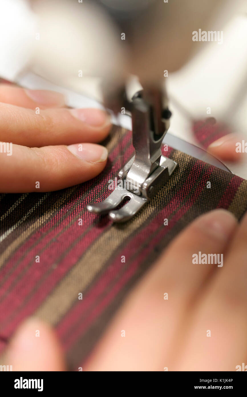 Fashion designer or student is sewing details of her new dress for ...