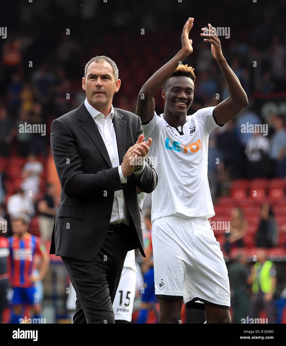 Swansea City manager Paul Clement and Tammy Abraham (right) applaud the fans after the Premier ...