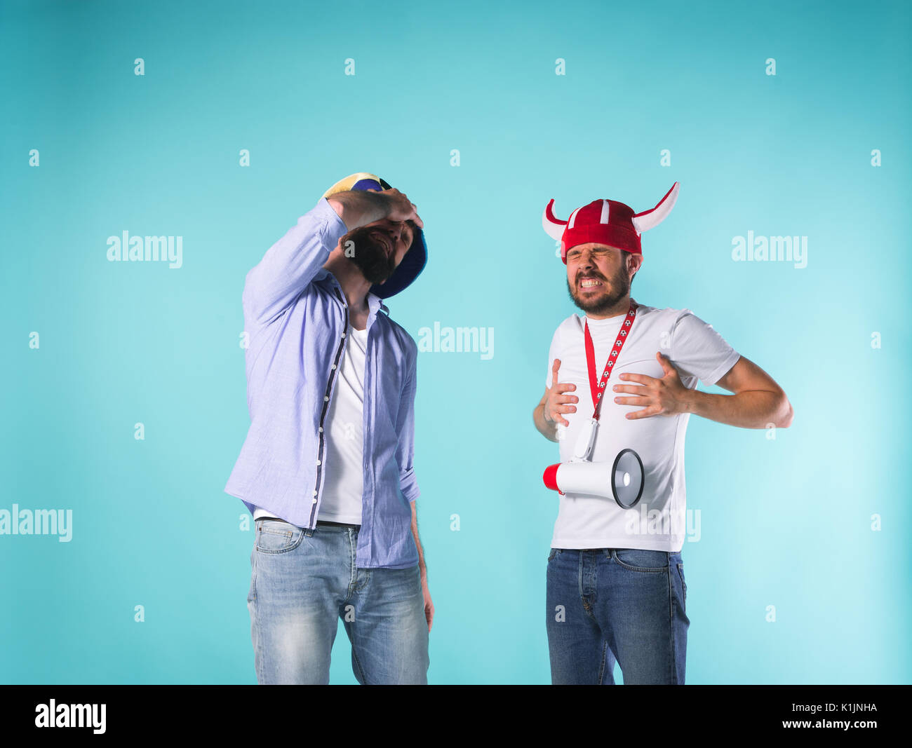 The two football fans over blue Stock Photo - Alamy