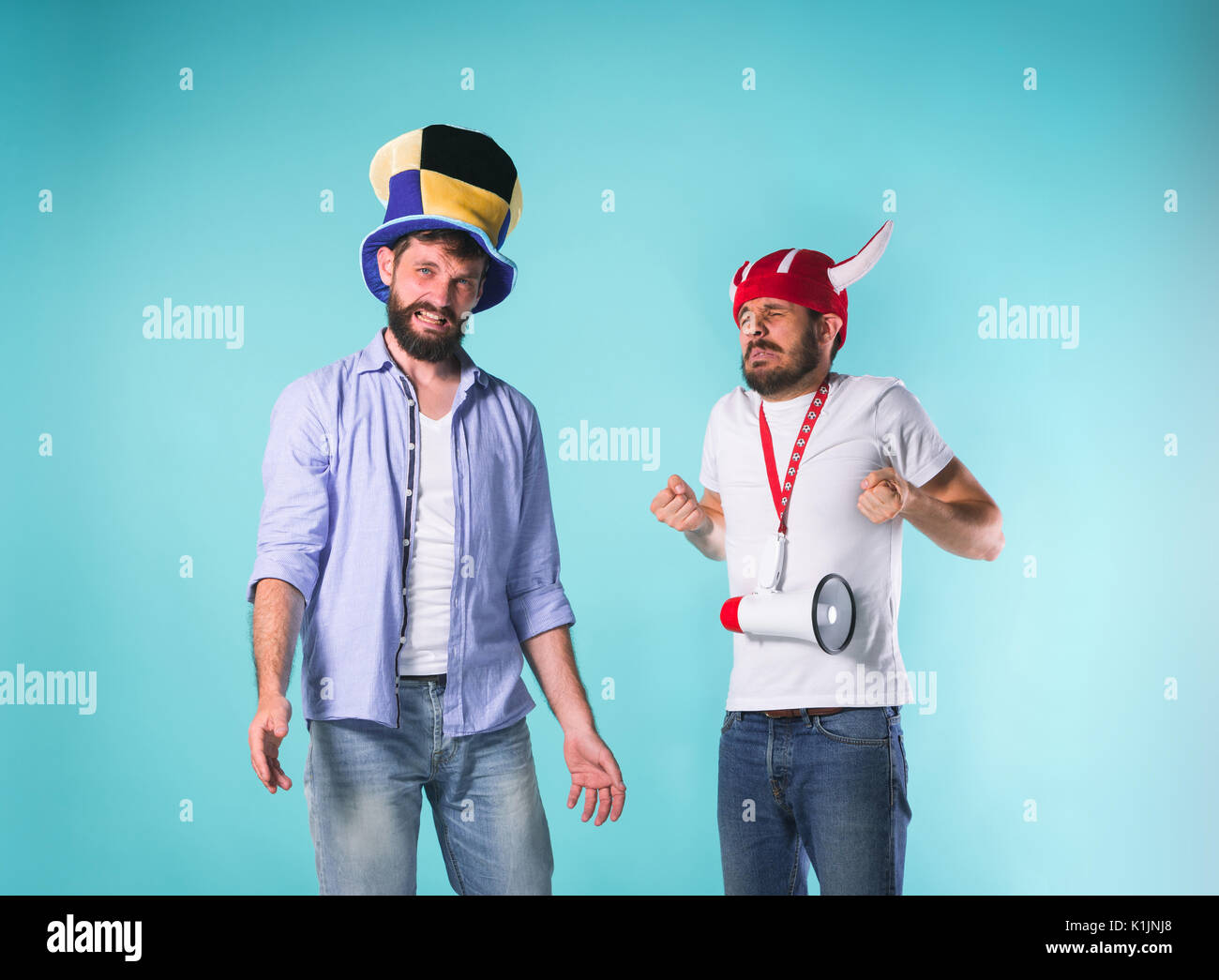 The two football fans over blue Stock Photo - Alamy