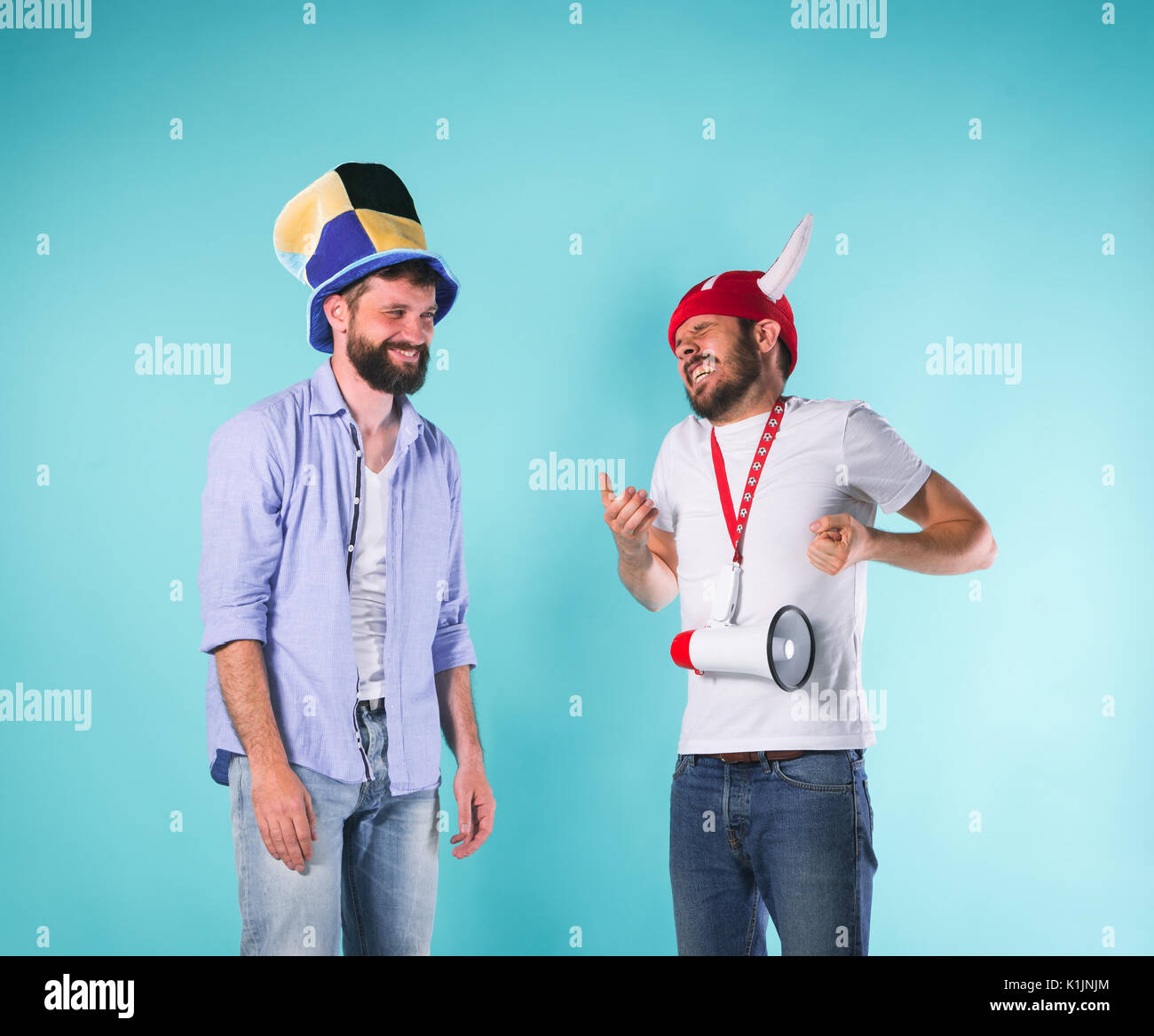 The two football fans over blue Stock Photo - Alamy