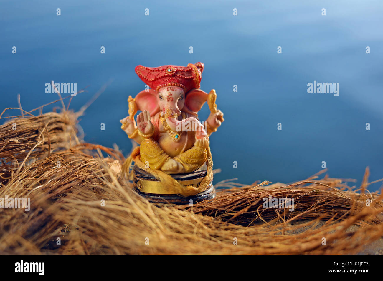 Lord Ganesha on coconut Stock Photo - Alamy