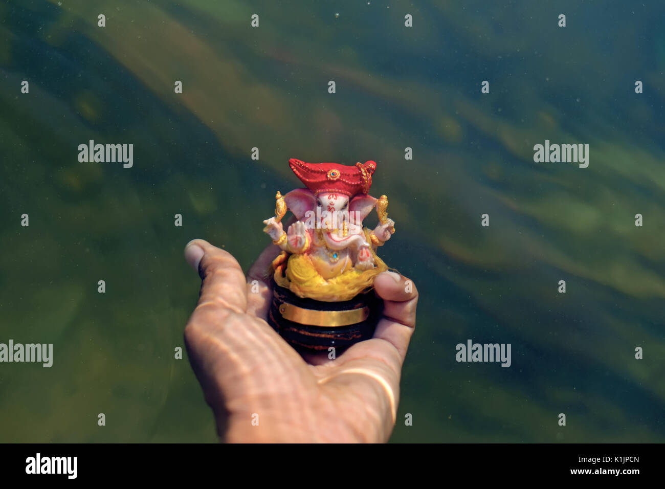 Lord Ganesha on hand Stock Photo - Alamy