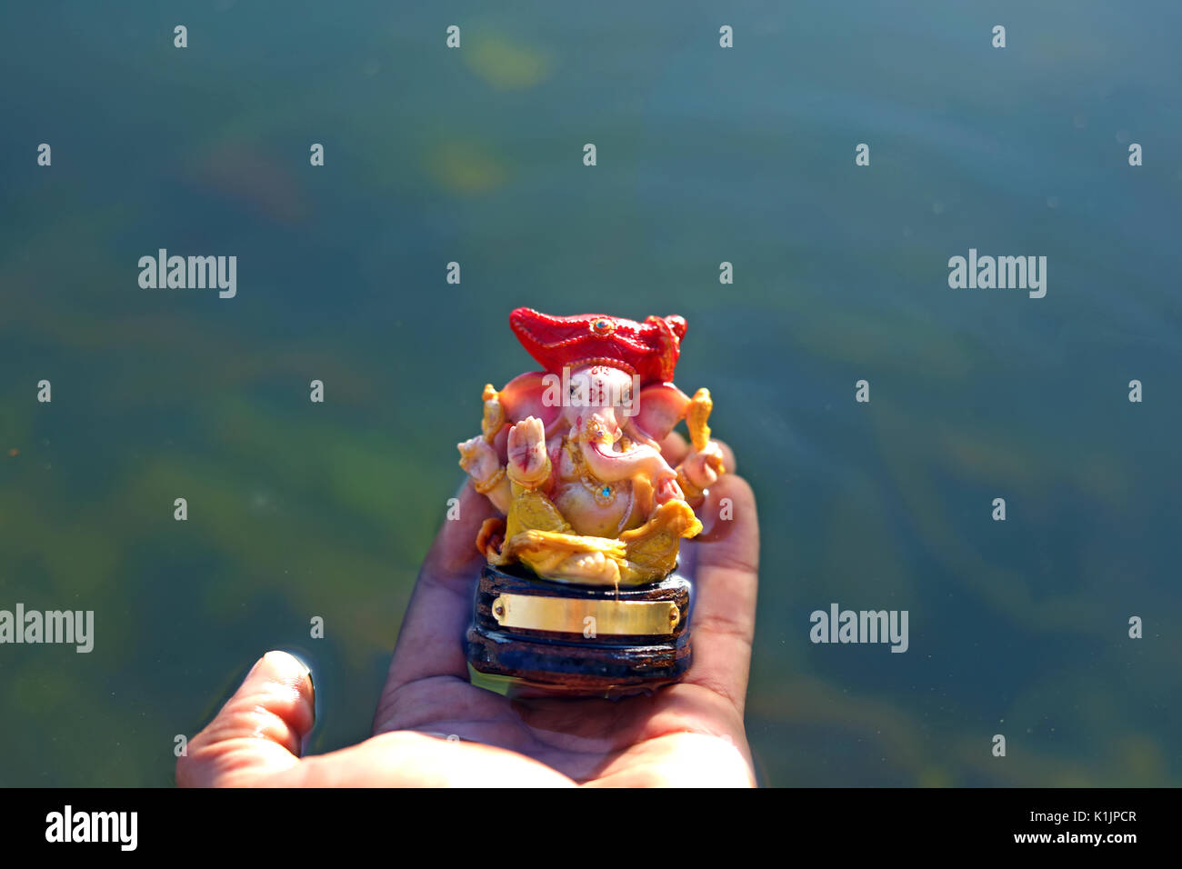 Lord Ganesha on hand Stock Photo - Alamy
