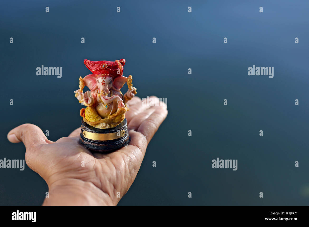 Lord Ganesha on hand Stock Photo - Alamy