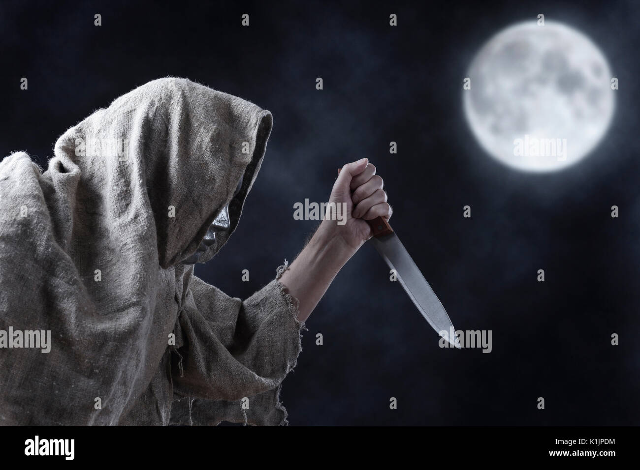 Man in iron mask with a big knife in his hand , Halloween concept Stock ...