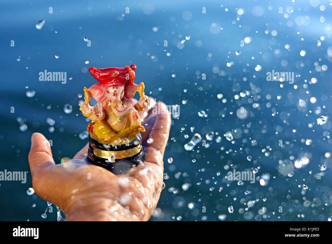 Lord Ganesha on hand Stock Photo - Alamy