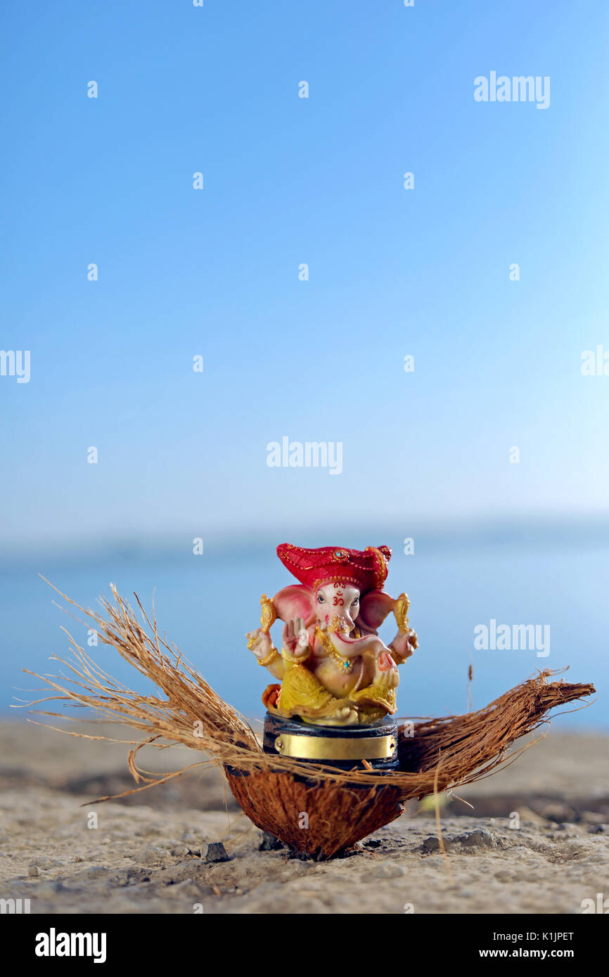 Lord Ganesha on coconut Stock Photo - Alamy