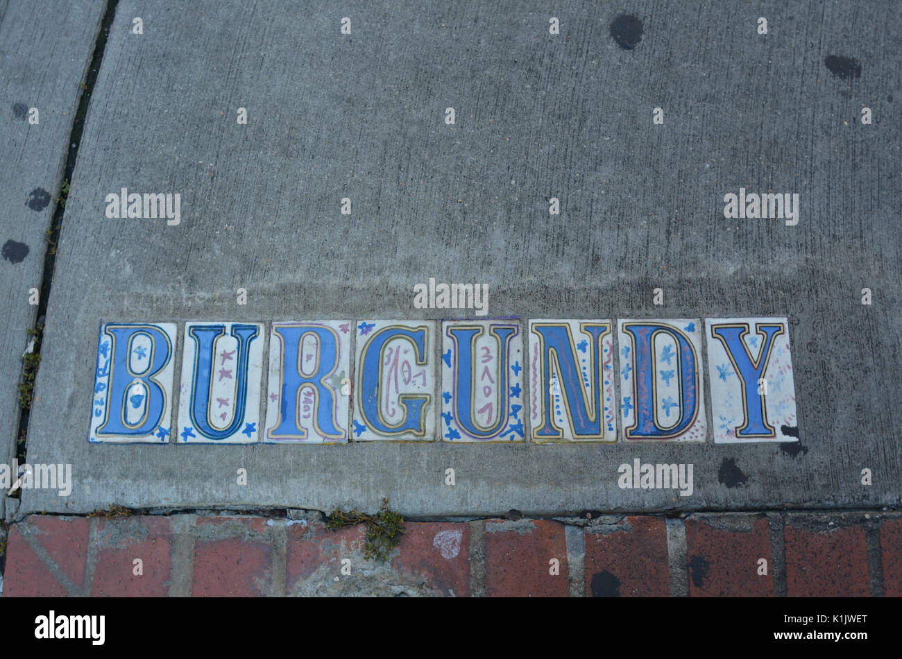 Burgundy word lettering ceramic tile street sign Stock Photo - Alamy