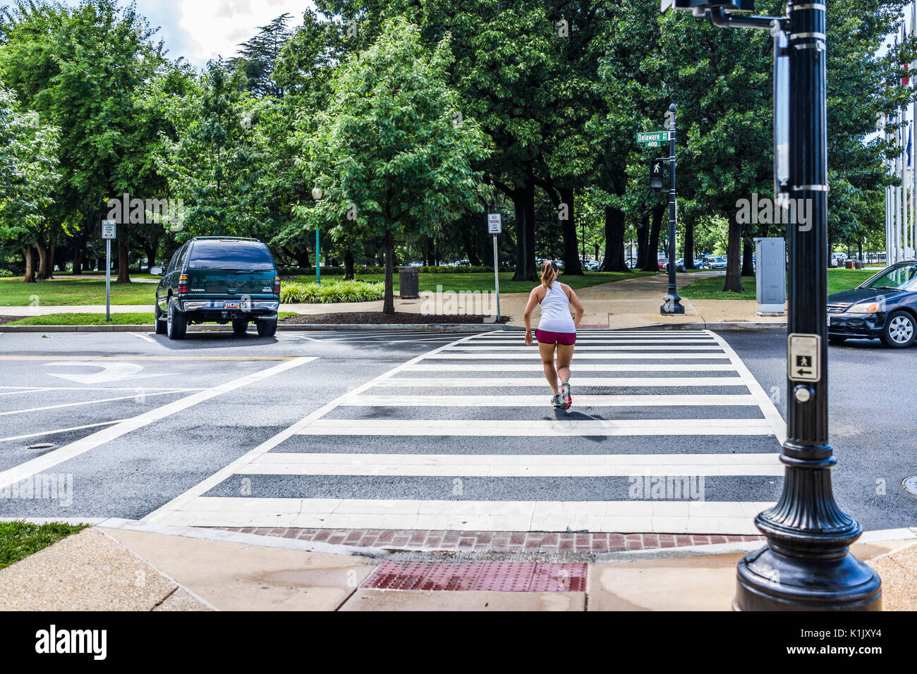 Washington DC, USA - July 1, 2017: Woman jogging crossing street by ...
