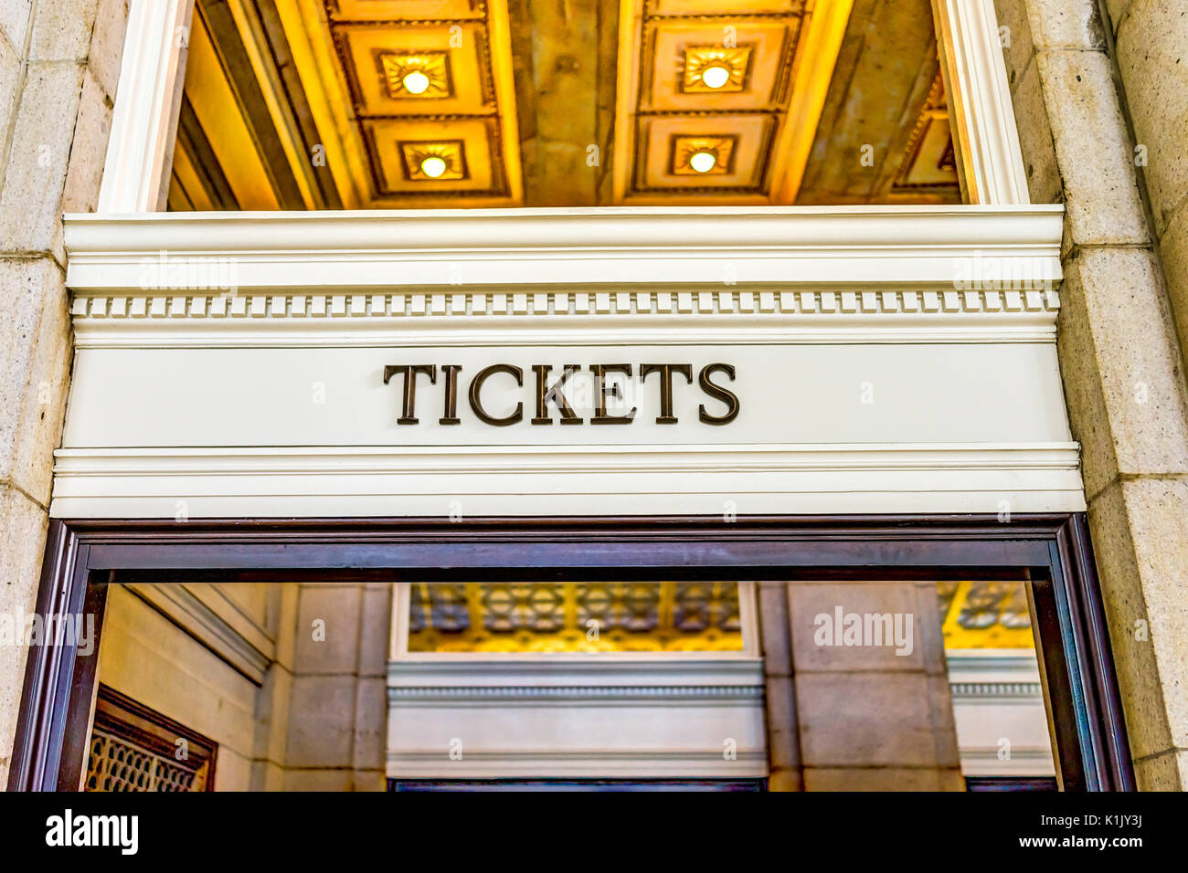 Transportation tickets sign inside building with golden lights Stock ...