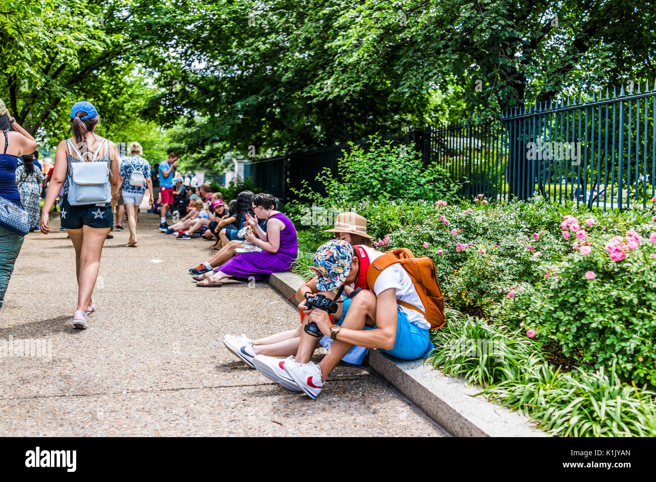 Washington DC, USA - July 3, 2017: People eating fast food on sidewalk ...