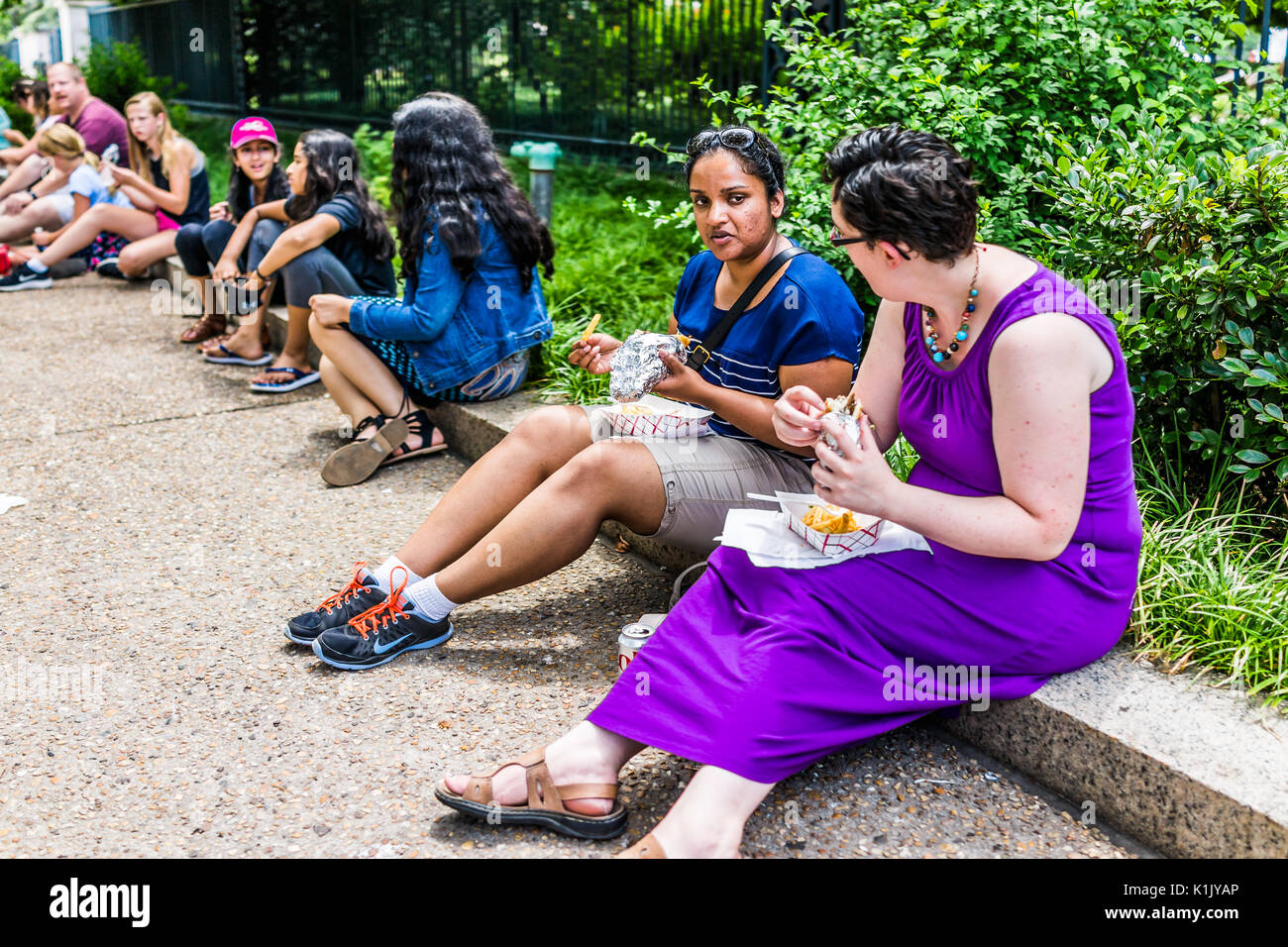 Washington DC, USA - July 3, 2017: People sitting eating fast food on ...
