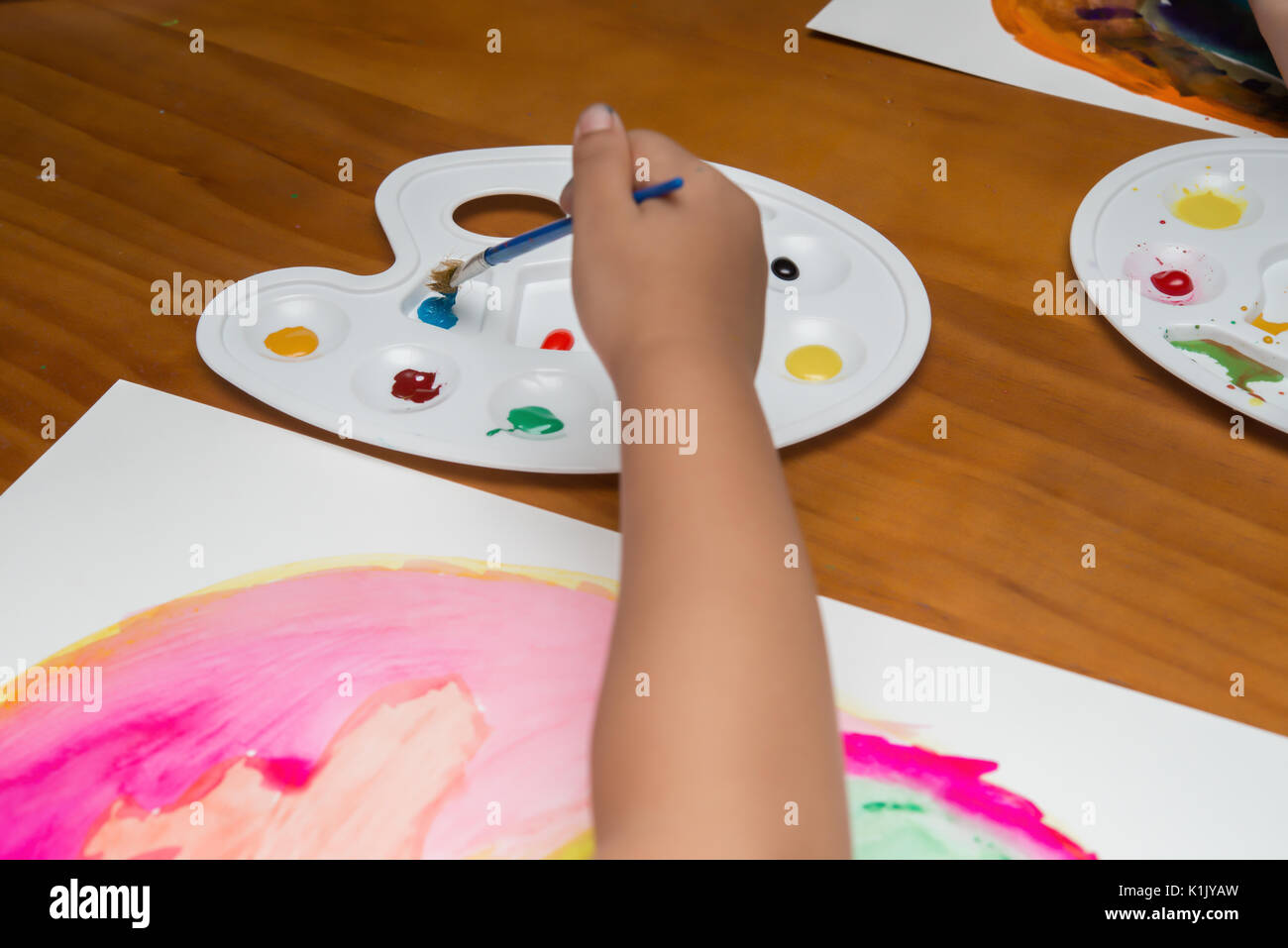 kid doing colorful painting Stock Photo - Alamy
