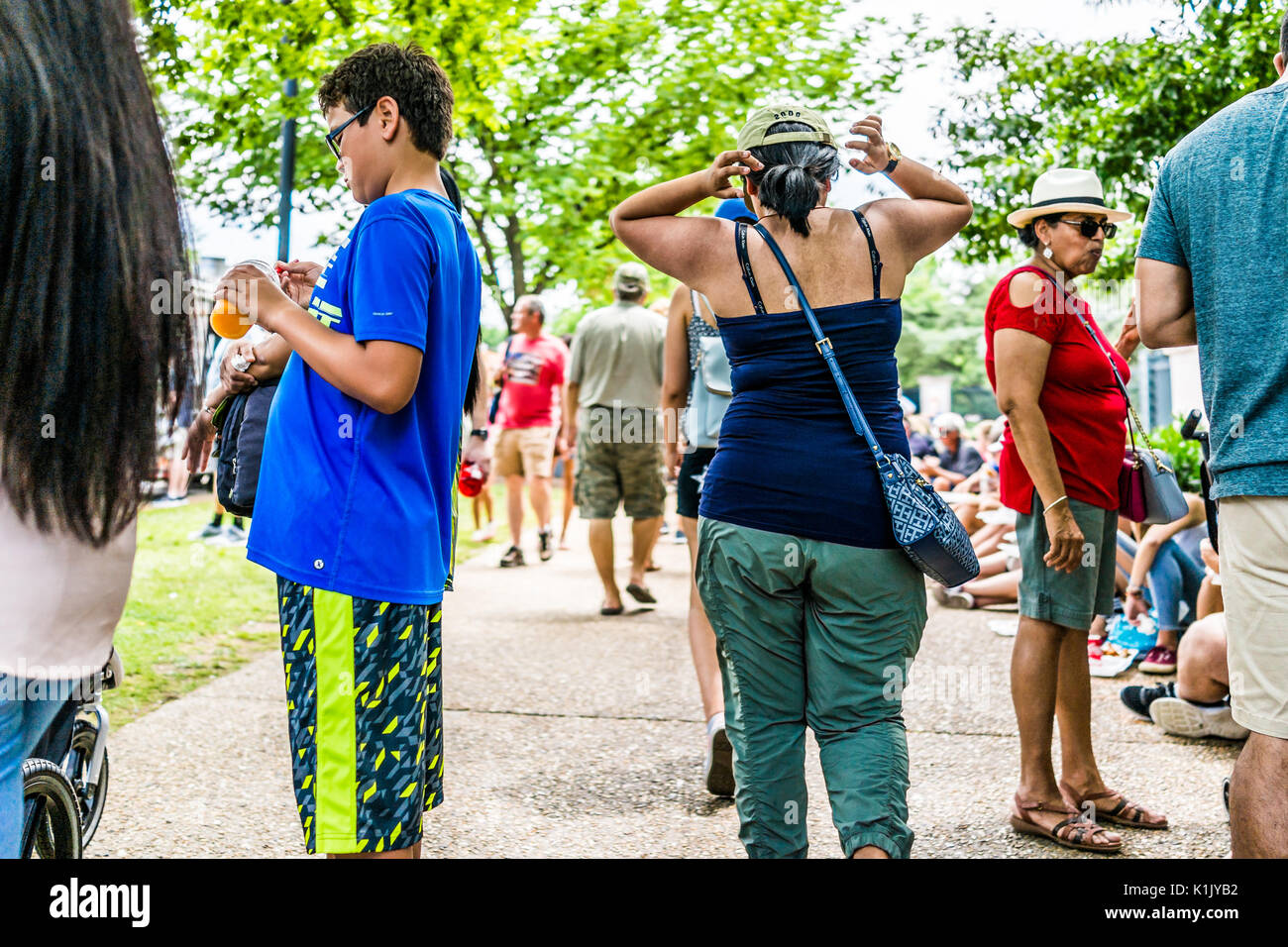 Washington DC, USA - July 3, 2017: People eating fast food on sidewalk ...