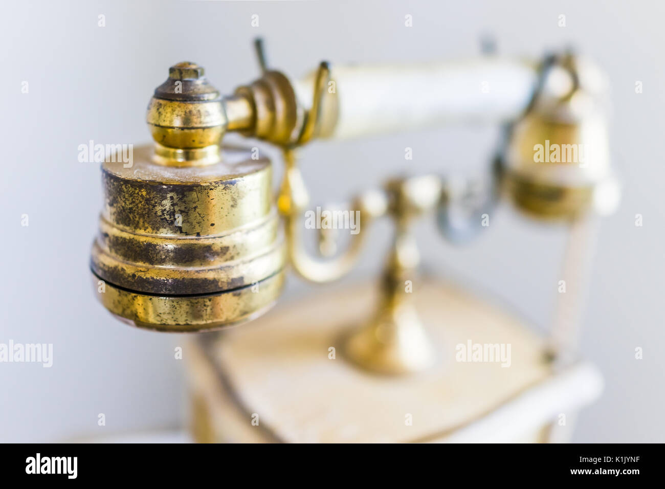 Macro closeup of old vintage golden retro telephone handle with peeling ...