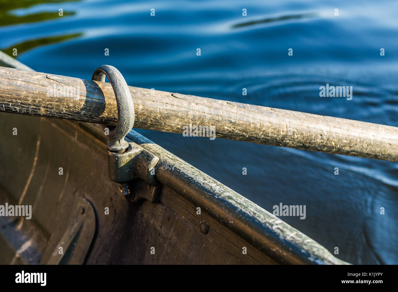 Row boat oar lock closeup in hole during summer with water Stock Photo ...