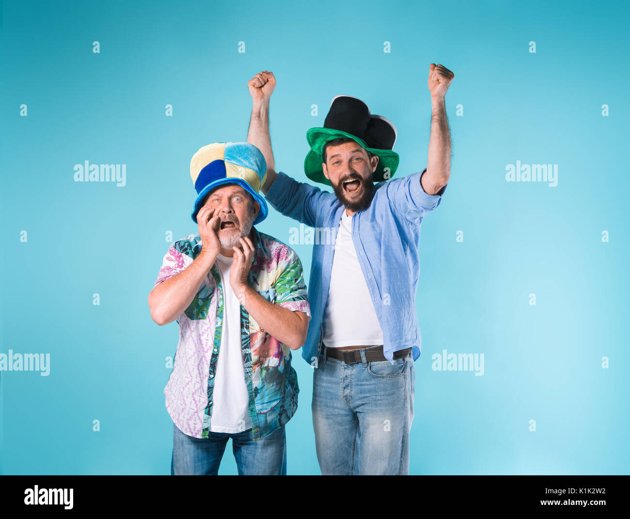 The two football fans over blue Stock Photo - Alamy