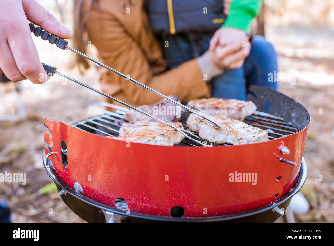 Hand holding cooking tongs hi-res stock photography and images - Alamy