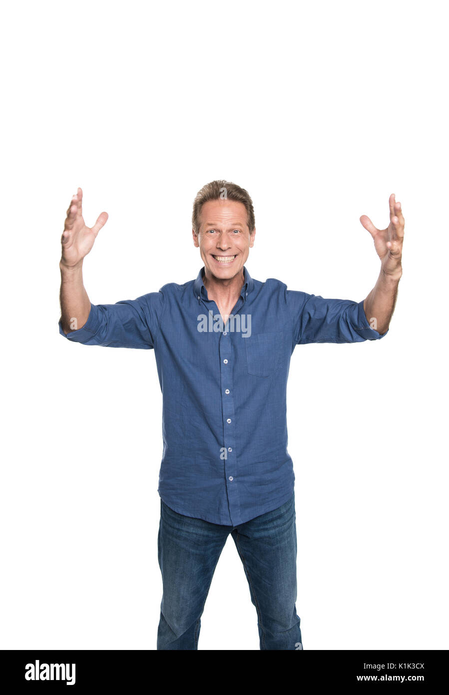 Man smiling presenting open hands Cut Out Stock Images & Pictures - Alamy