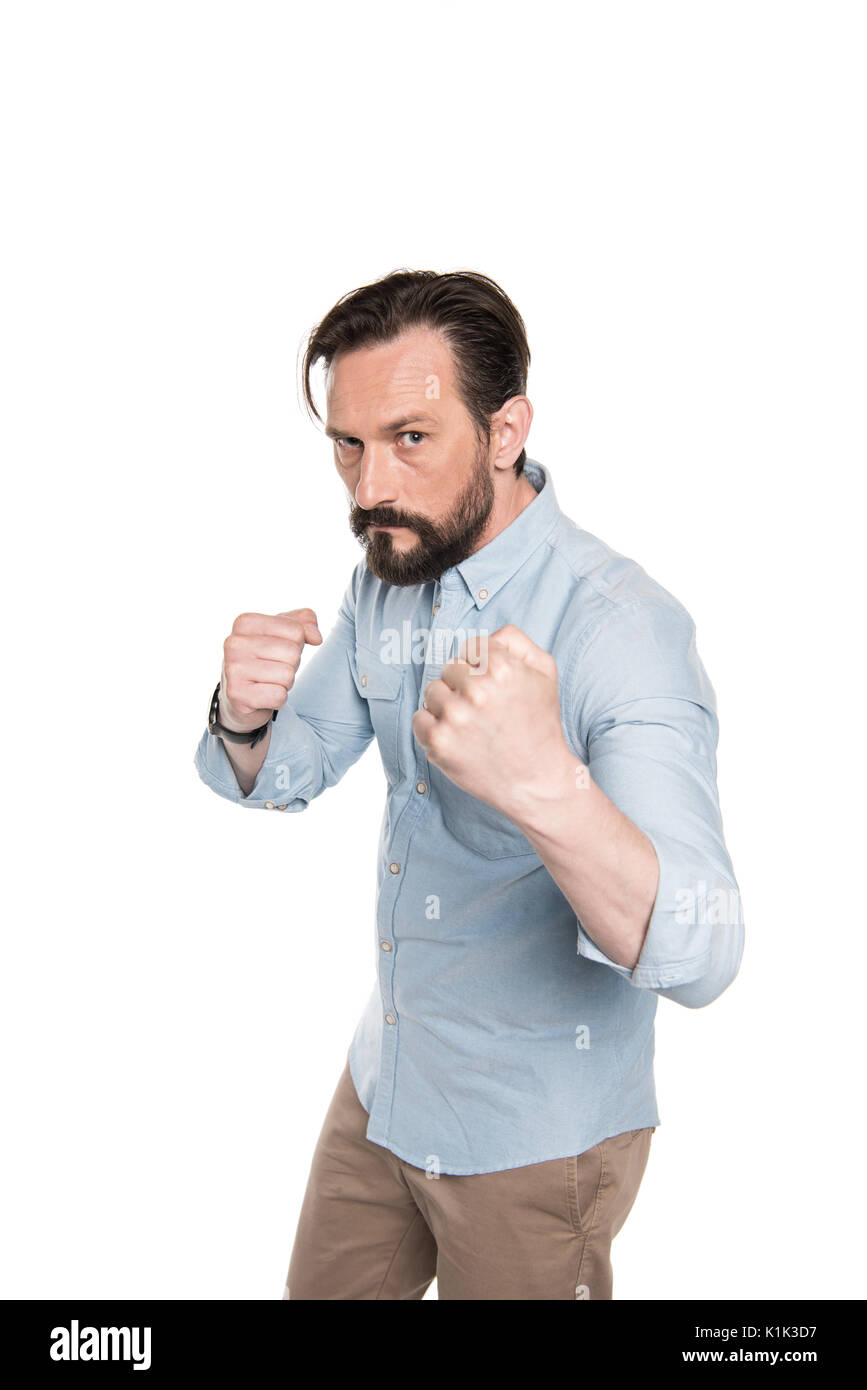 Aggressive bearded man standing in boxing pose and looking at camera ...