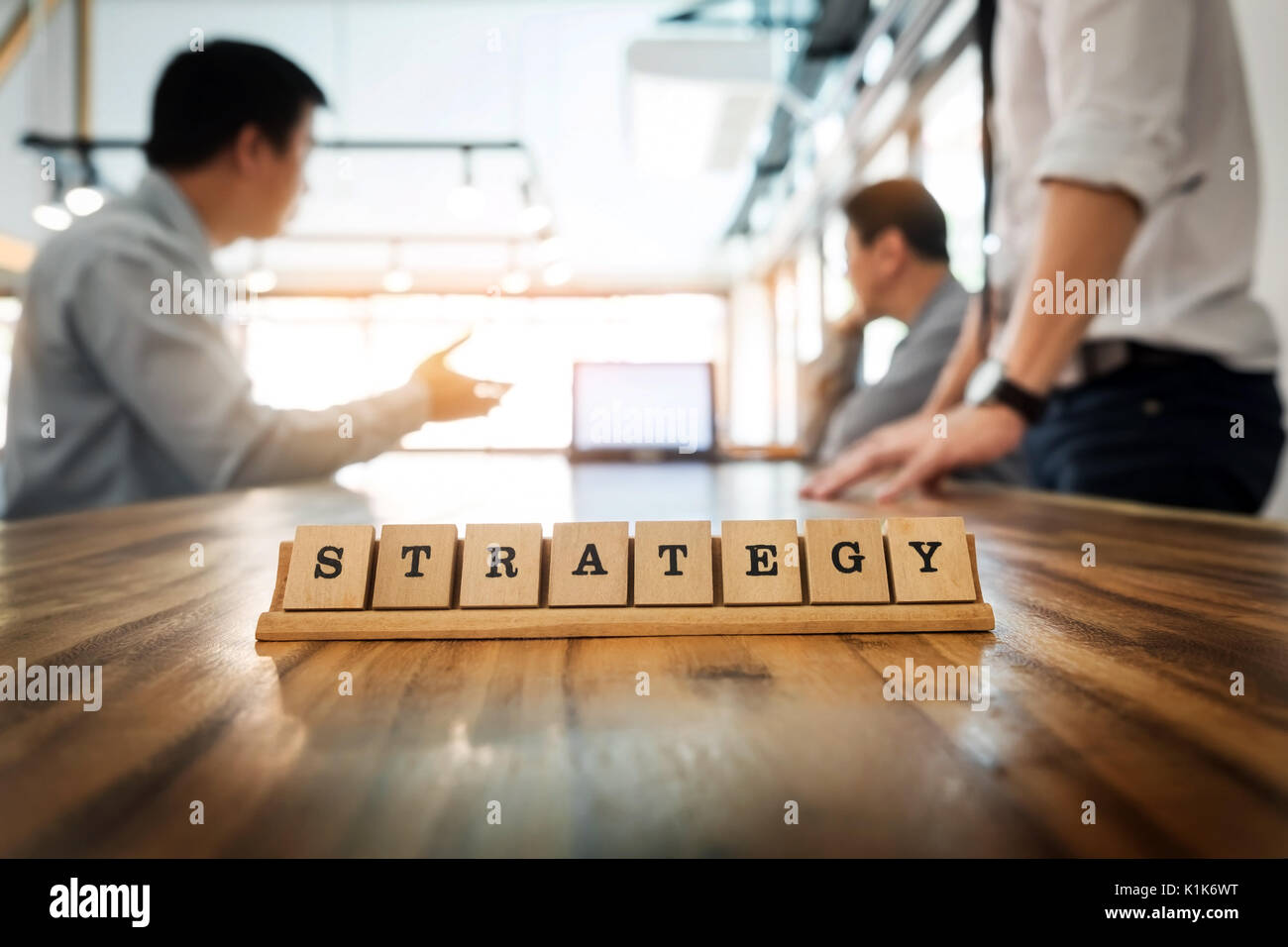 Strategy word on wood table with Business team work discussion together ...