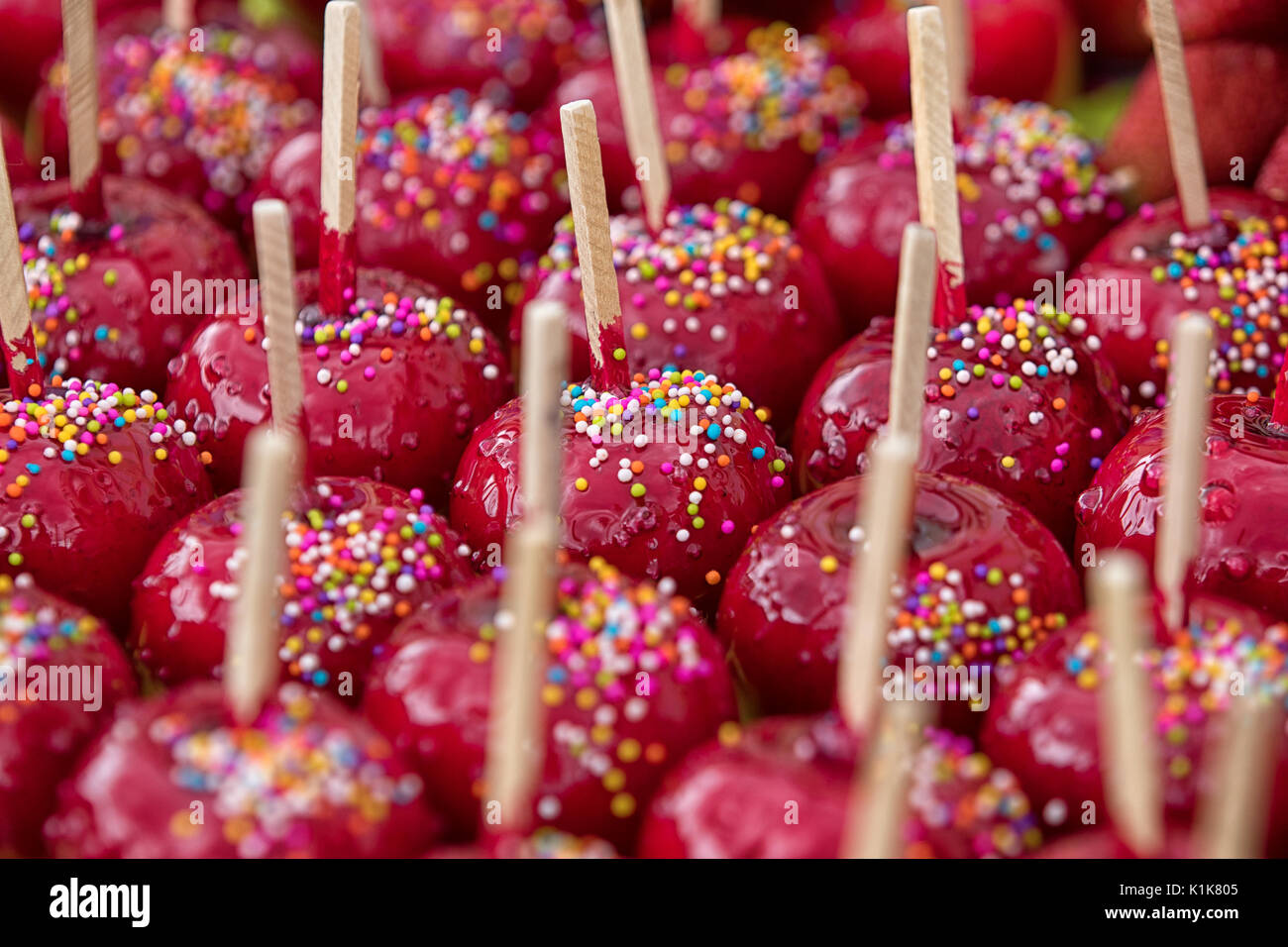 apples coated in colourful sugar glaze in Ecuador Stock Photo - Alamy