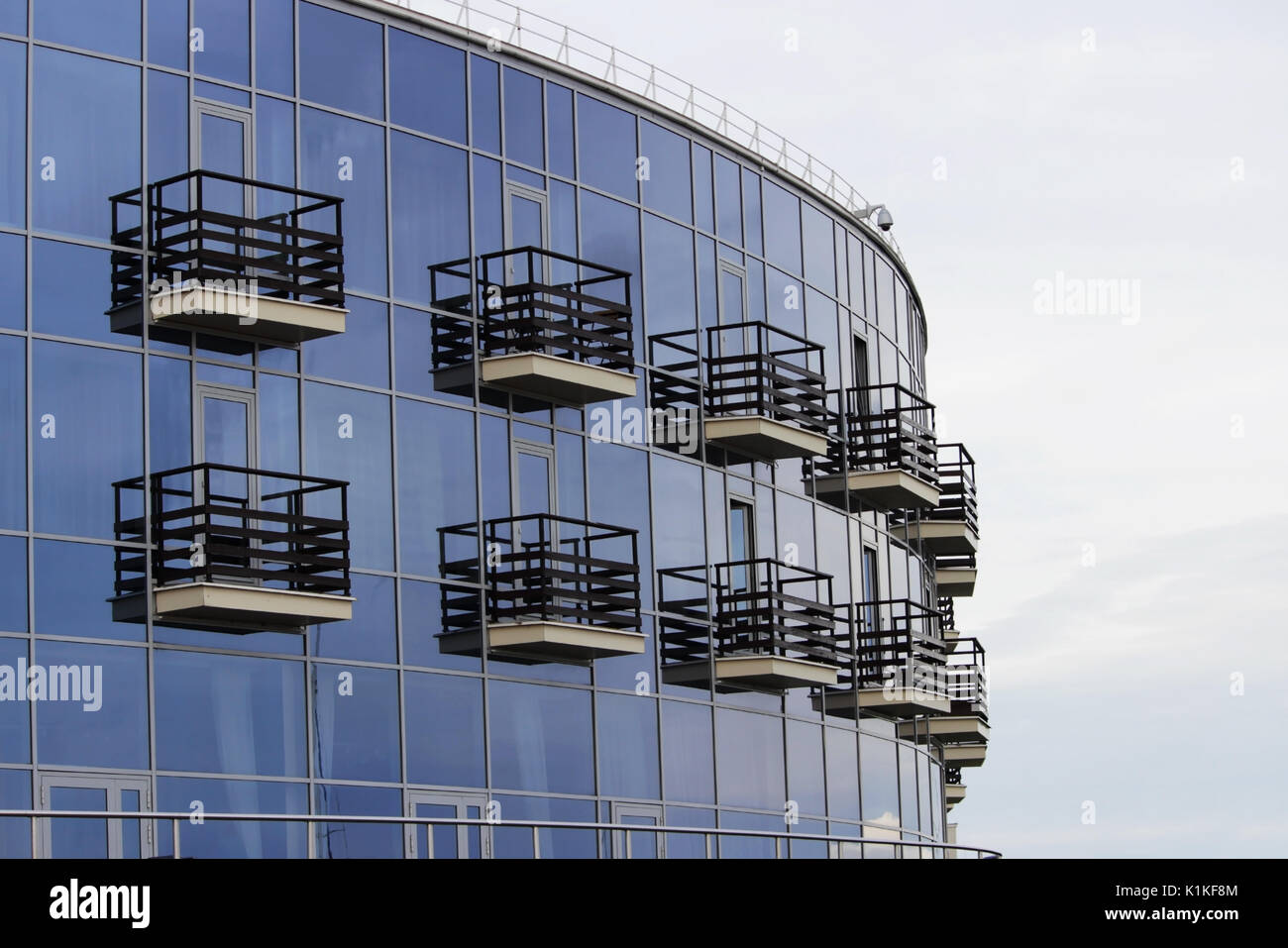 big transparent windows office building on a sky background Stock Photo ...