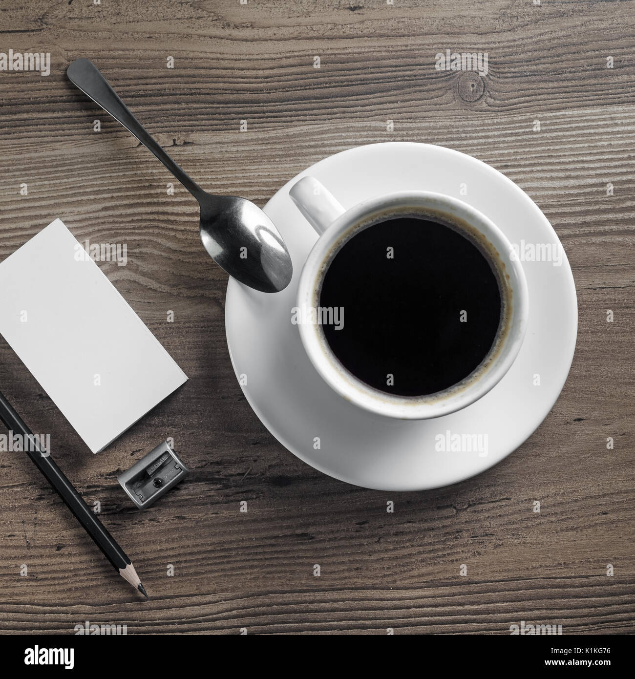 Still life with coffee cup, bank business cards, pencil and eraser on ...