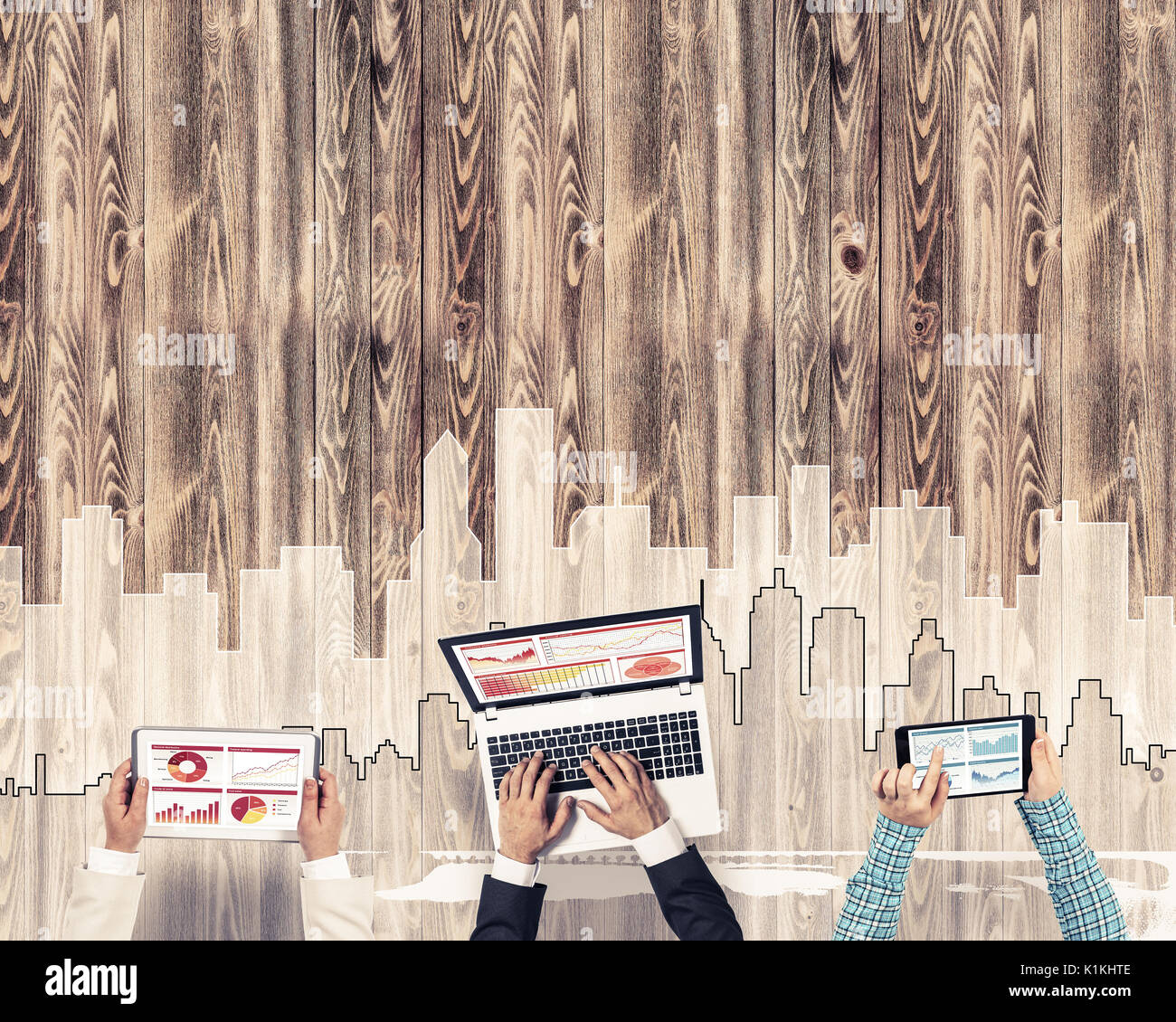 Group of three people with devices in hands working together as symbol ...