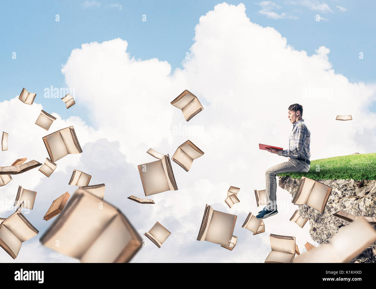 Young man floating on island in blue sky with red book in hands Stock ...