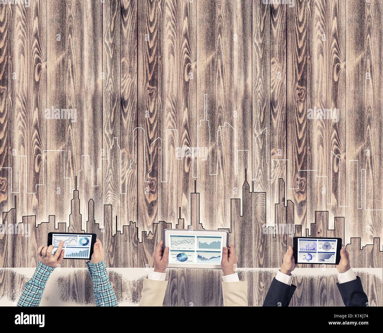 Group of three people with devices in hands working together as symbol ...