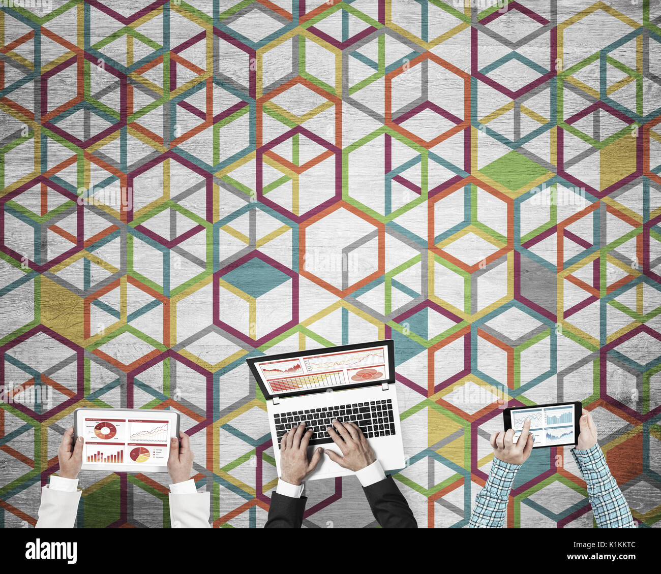 Group of three people with devices in hands working together as symbol ...