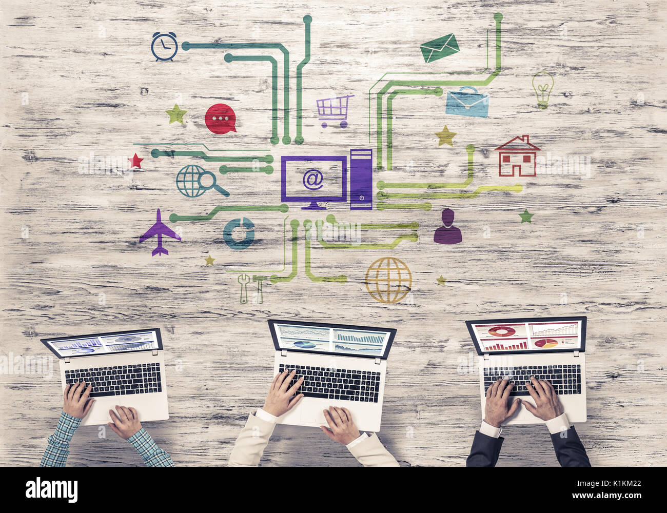 Group of three people with devices in hands working together as symbol ...