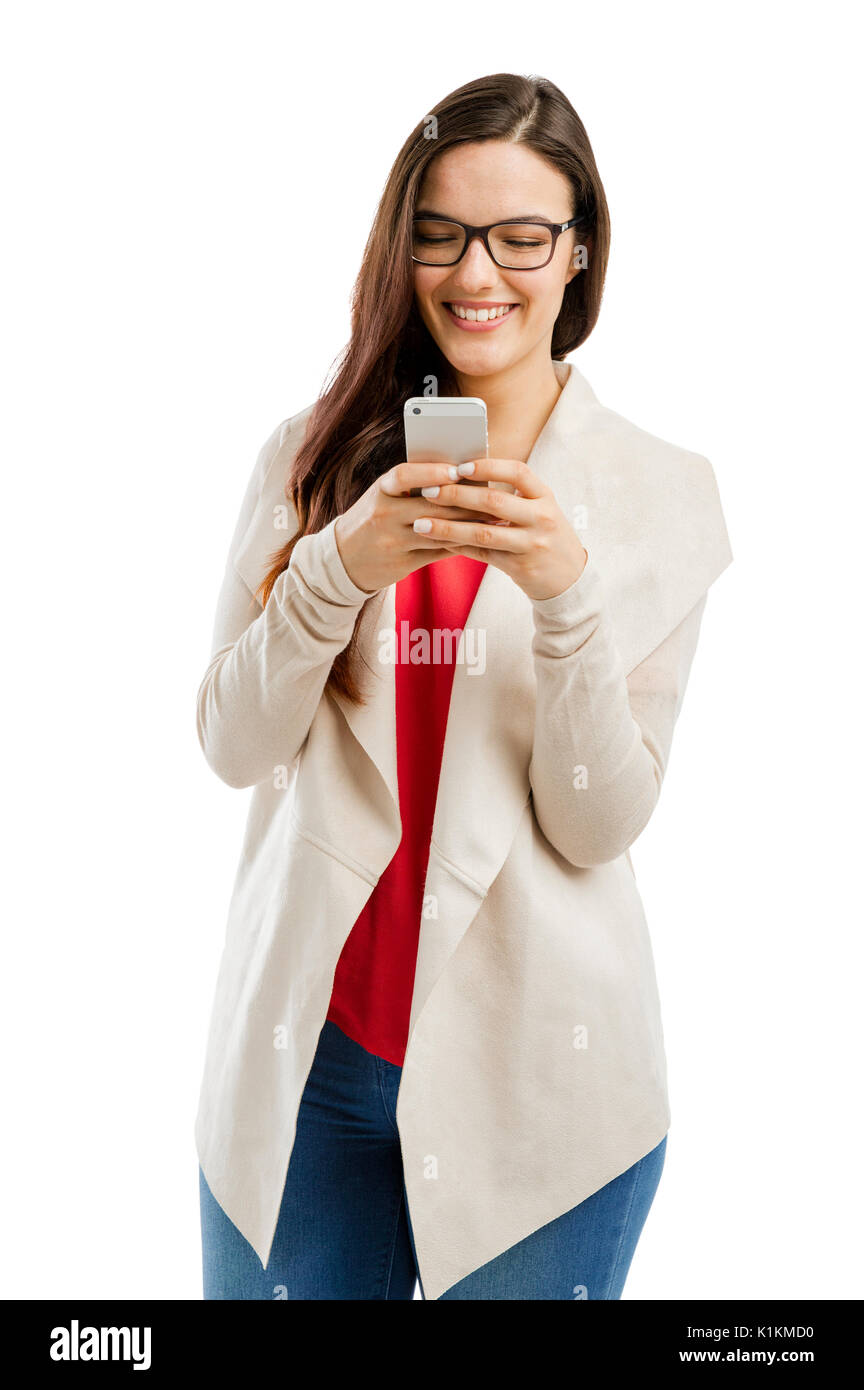 Beautiful woman sending a text message, isolated over white background ...