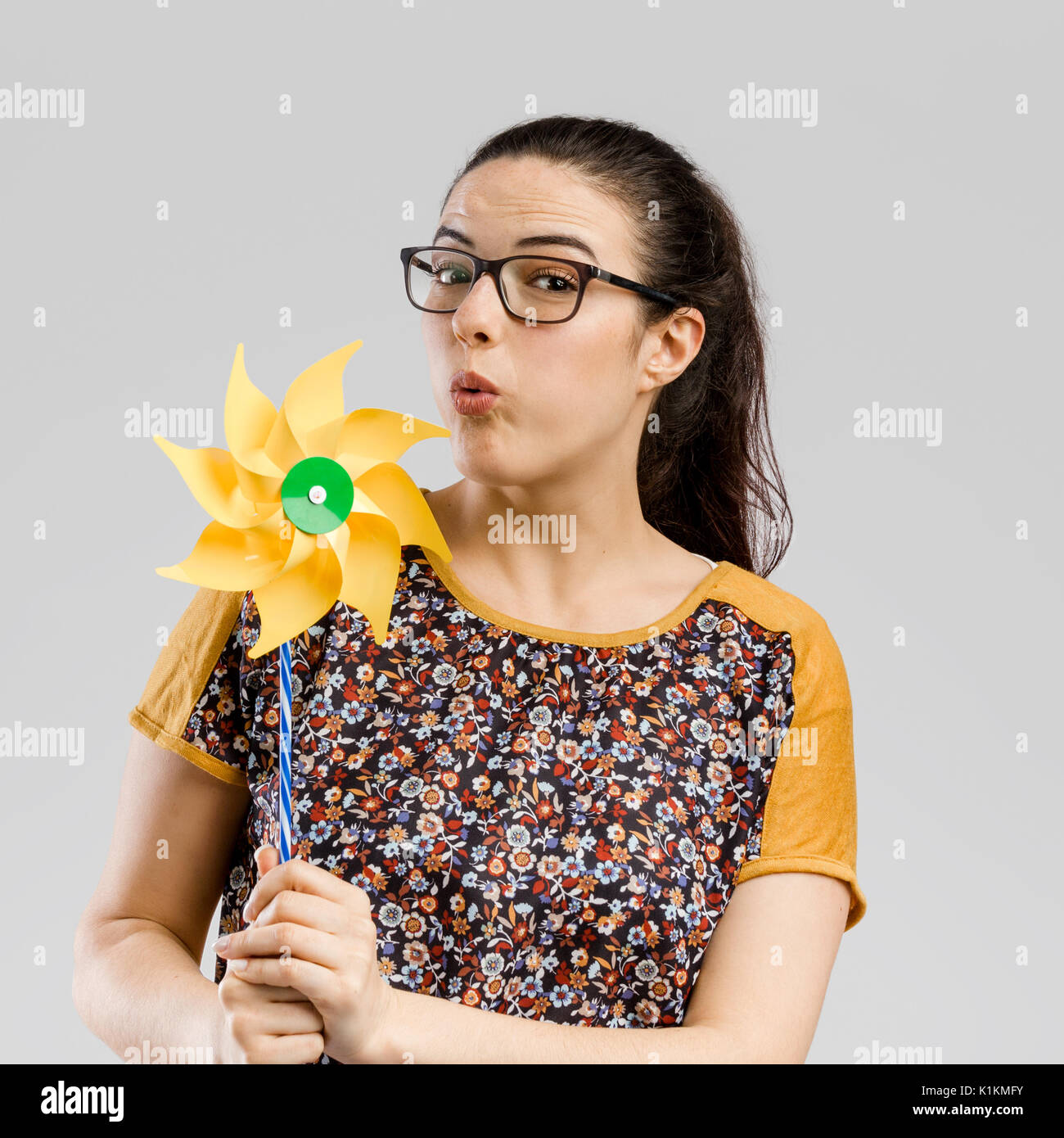 Portrait of Beautilful woman blowing a windmill Stock Photo - Alamy Portrait of Beautilful woman blowing a windmill Stock Photo - Alamy