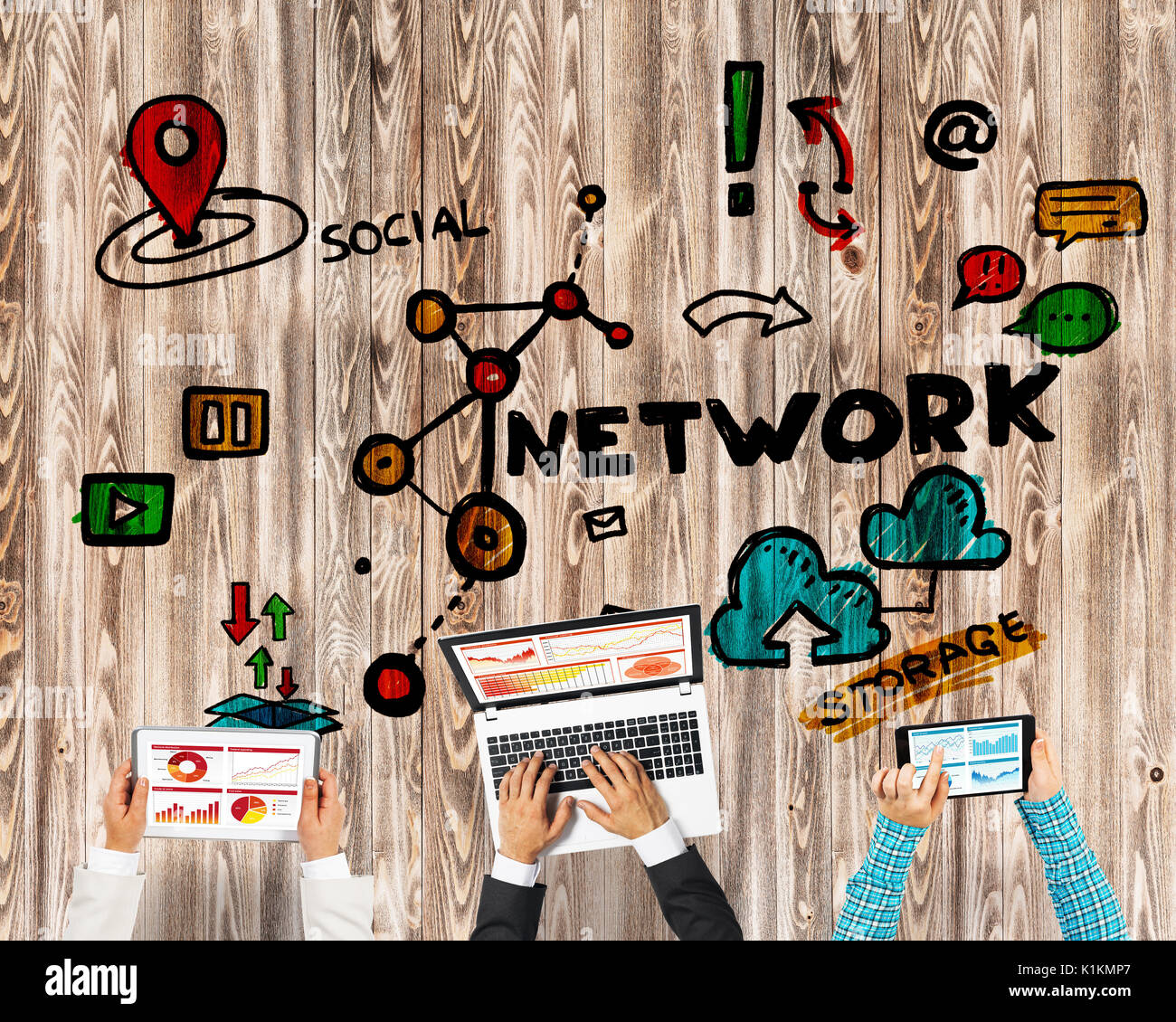 Group of three people with devices in hands working together as symbol ...