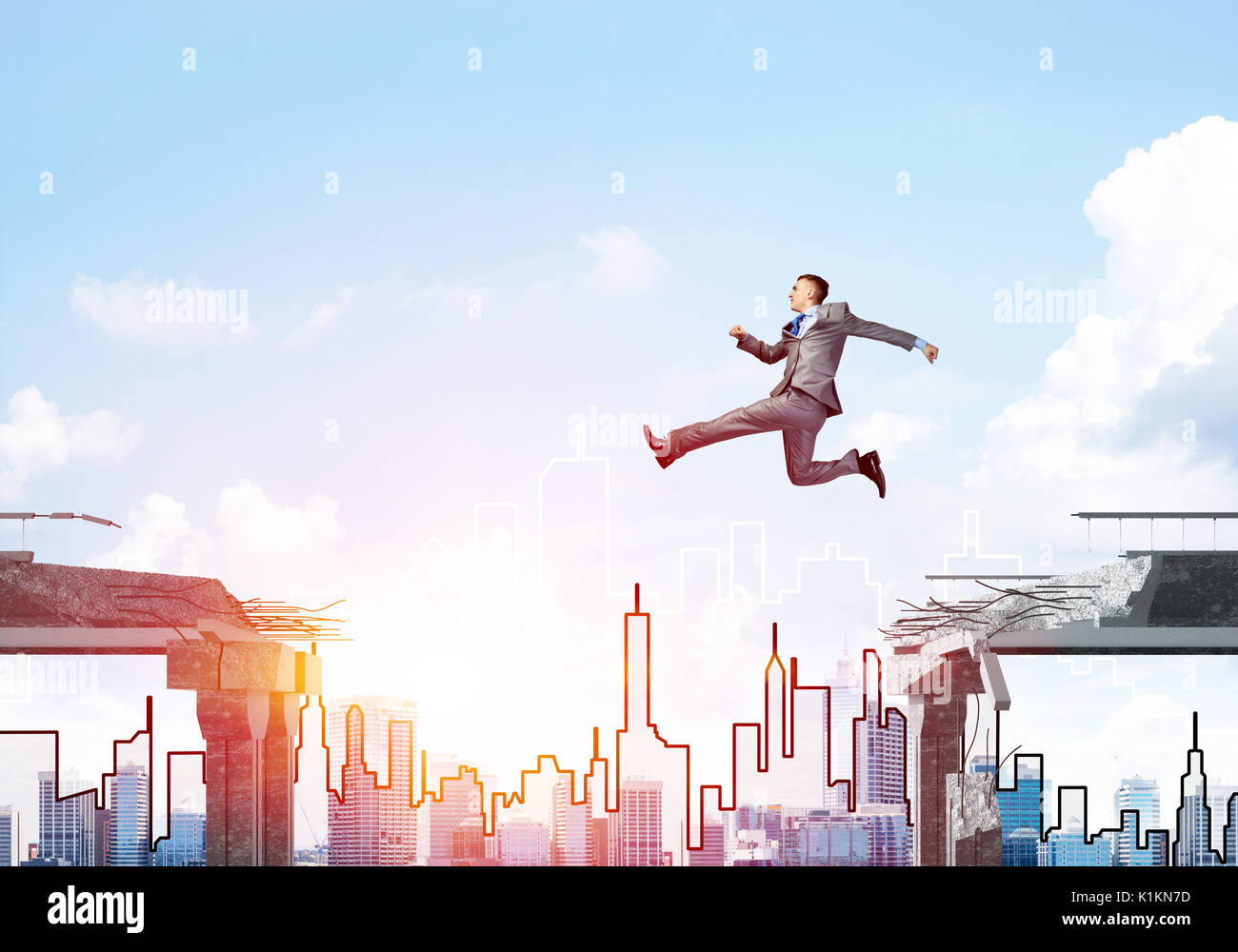 Businessman jumping over gap in concrete bridge as symbol of overcoming ...