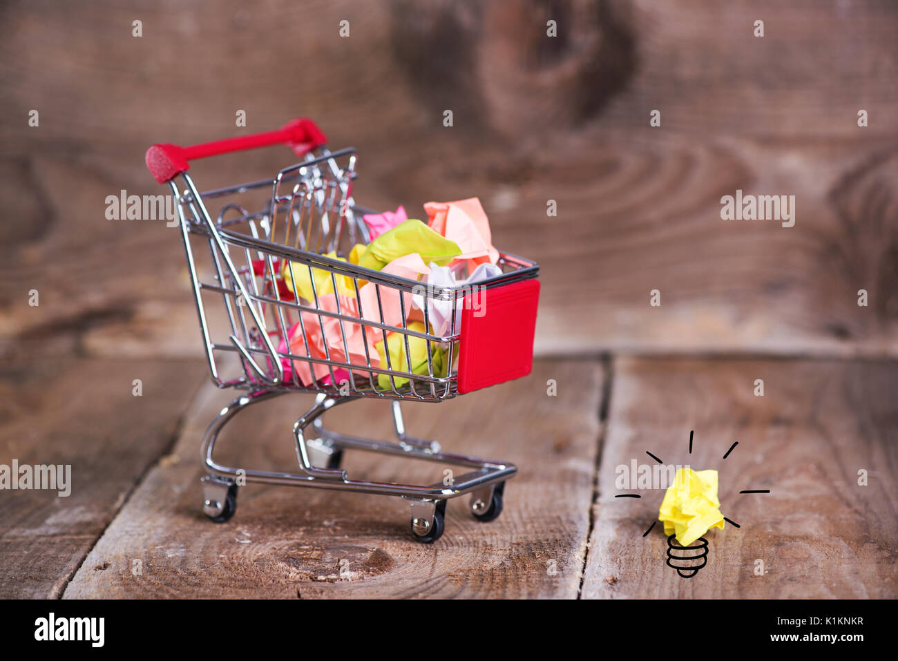 Shopping cart and small paper balls. Recylcing concept with color paper ...