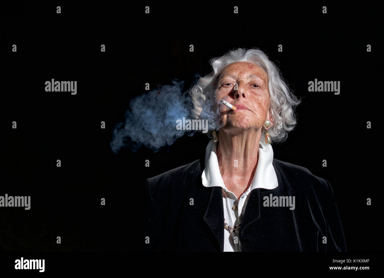 Old lady smoking cigarette hi-res stock photography and images - Alamy