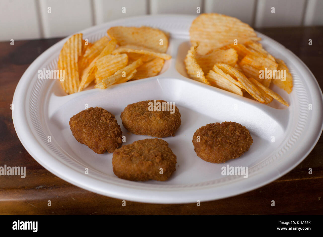 Four chicken nuggets and two stacks of potato chips Stock Photo - Alamy