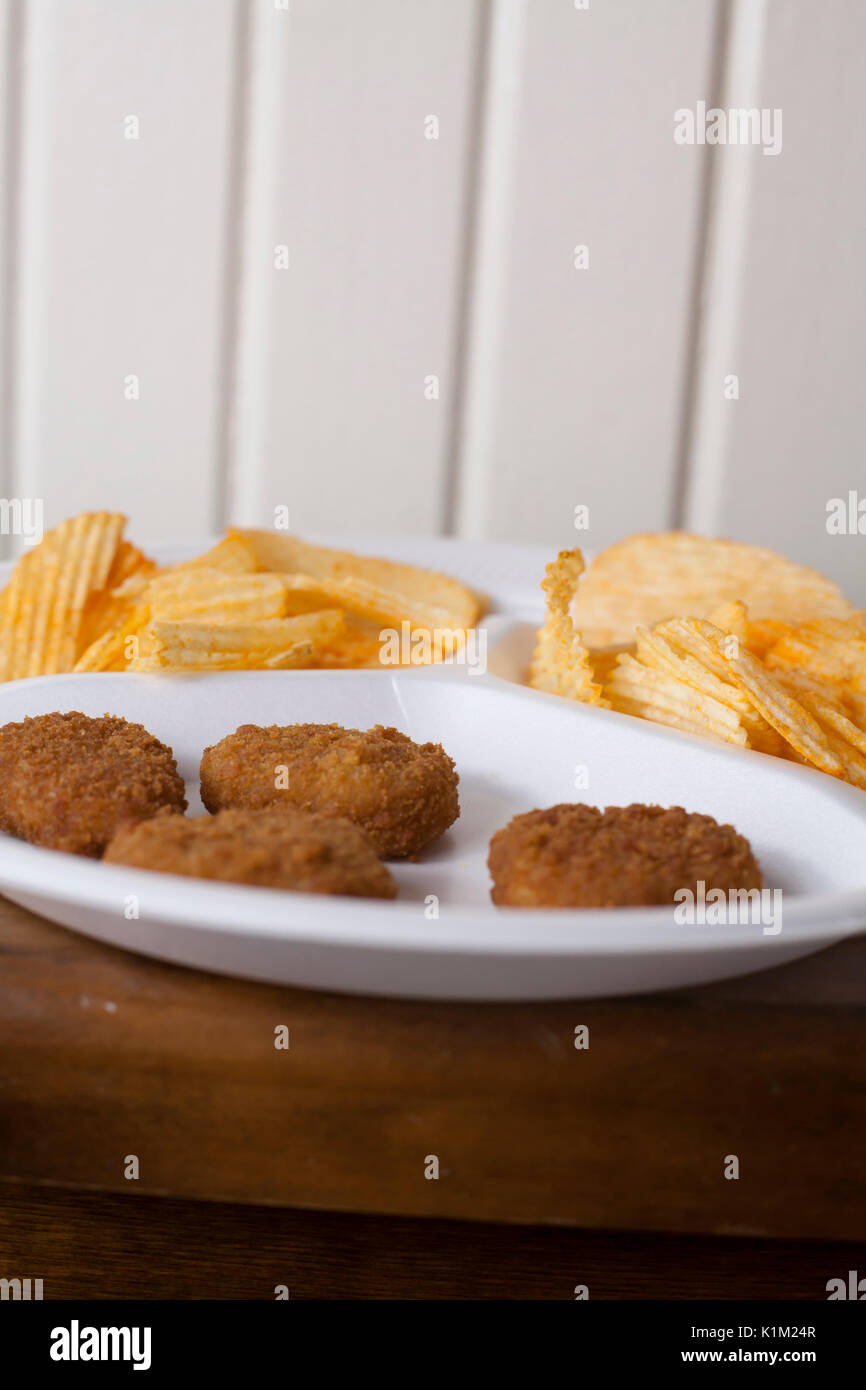 Four chicken nuggets and two stacks of potato chips Stock Photo - Alamy